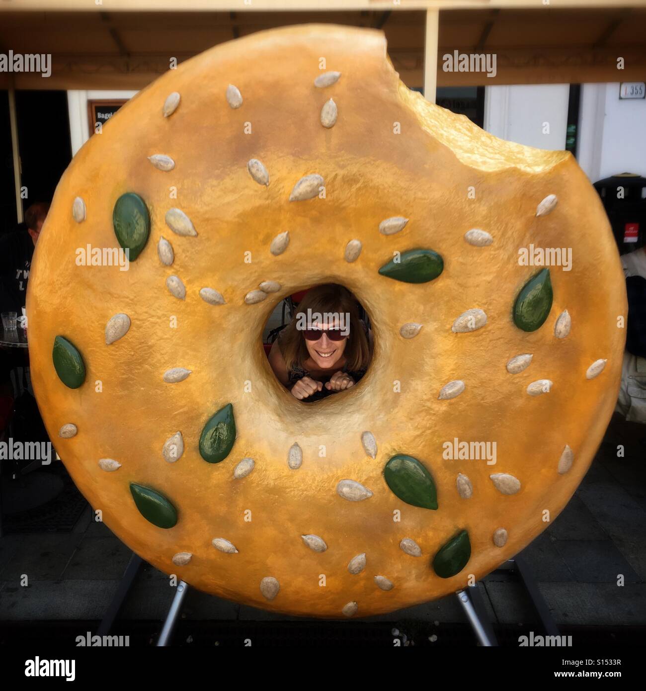 Taking a tacky photo of a head inside a giant bagel in Bratislava ...