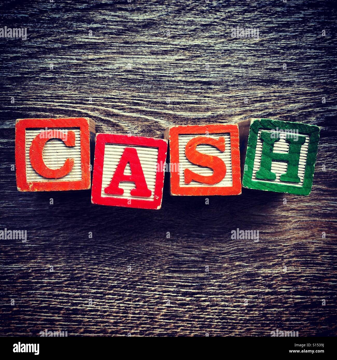 CASH word written with alphabet wood block letter toys Stock Photo - Alamy