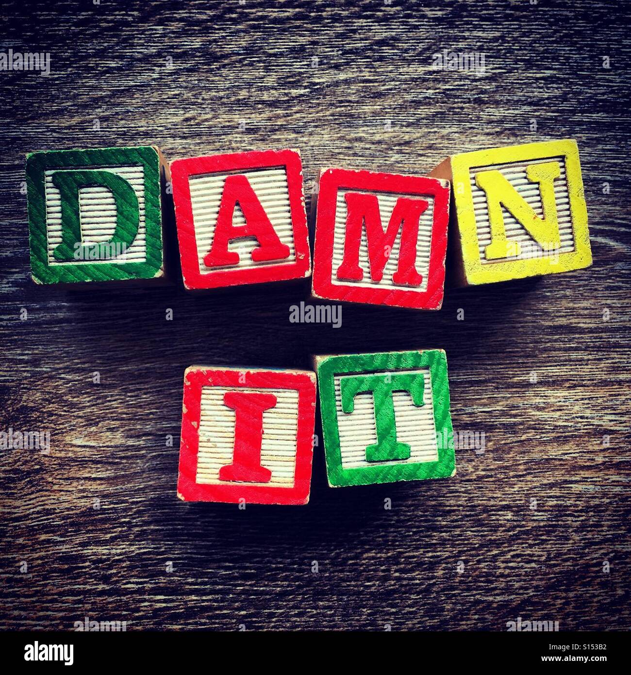 DAMN IT word written with alphabet wood block letter toys Stock Photo ...
