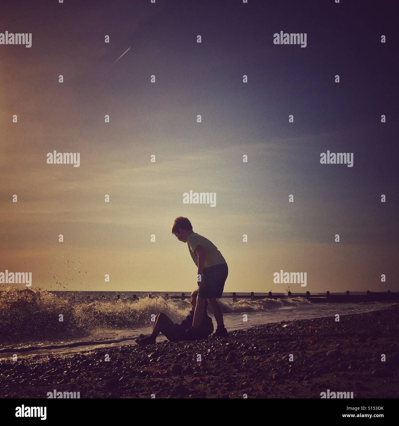 Boys playing on beach Stock Photo - Alamy