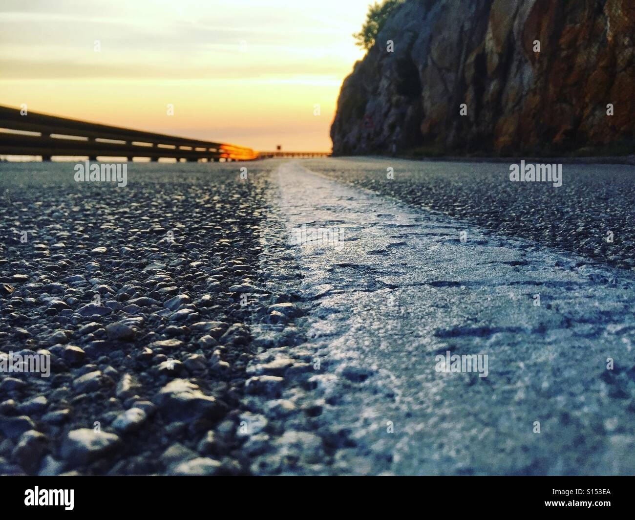 Asphalt road surface close up at sunset Stock Photo - Alamy