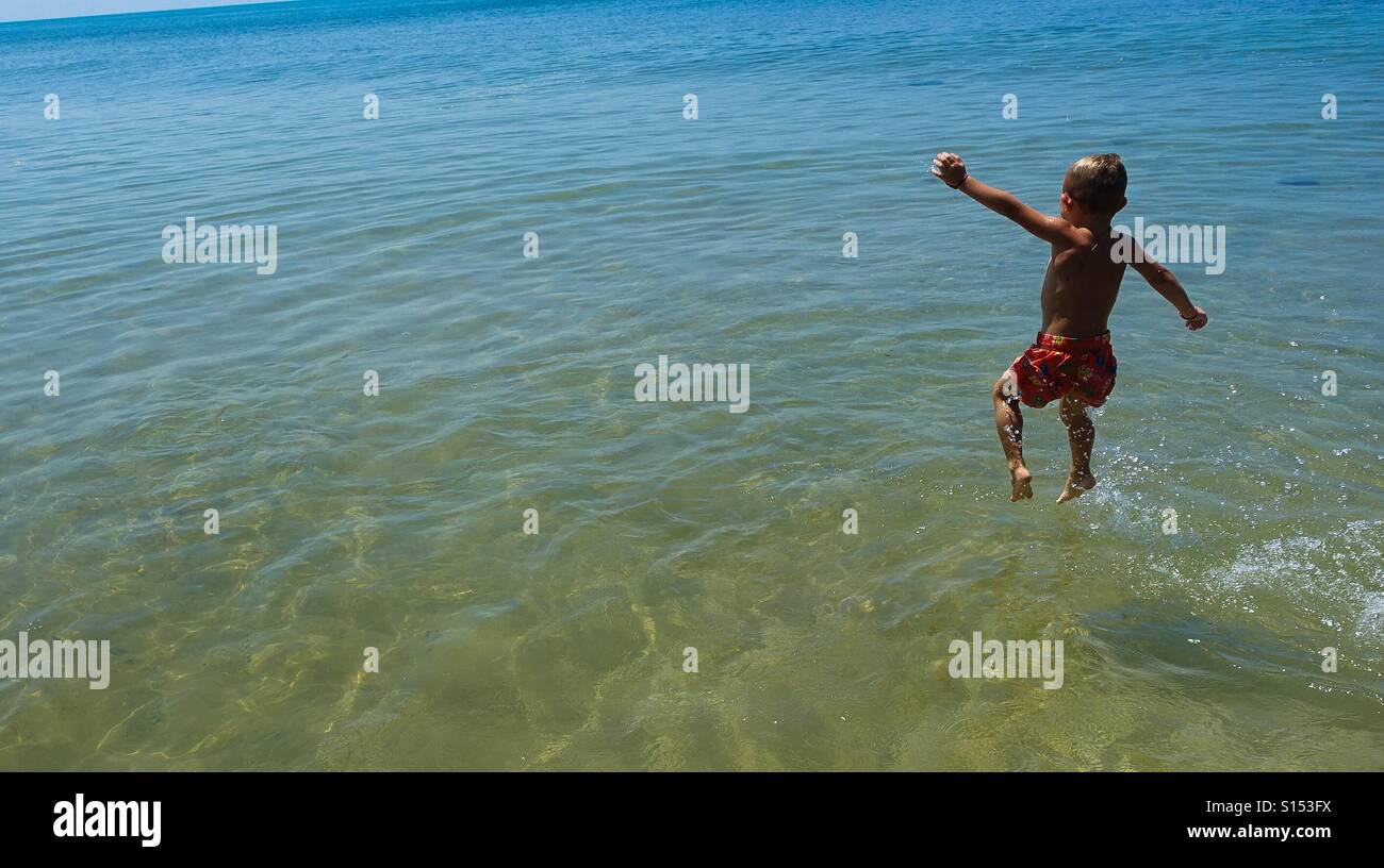 Boy jumping into water hi-res stock photography and images - Alamy