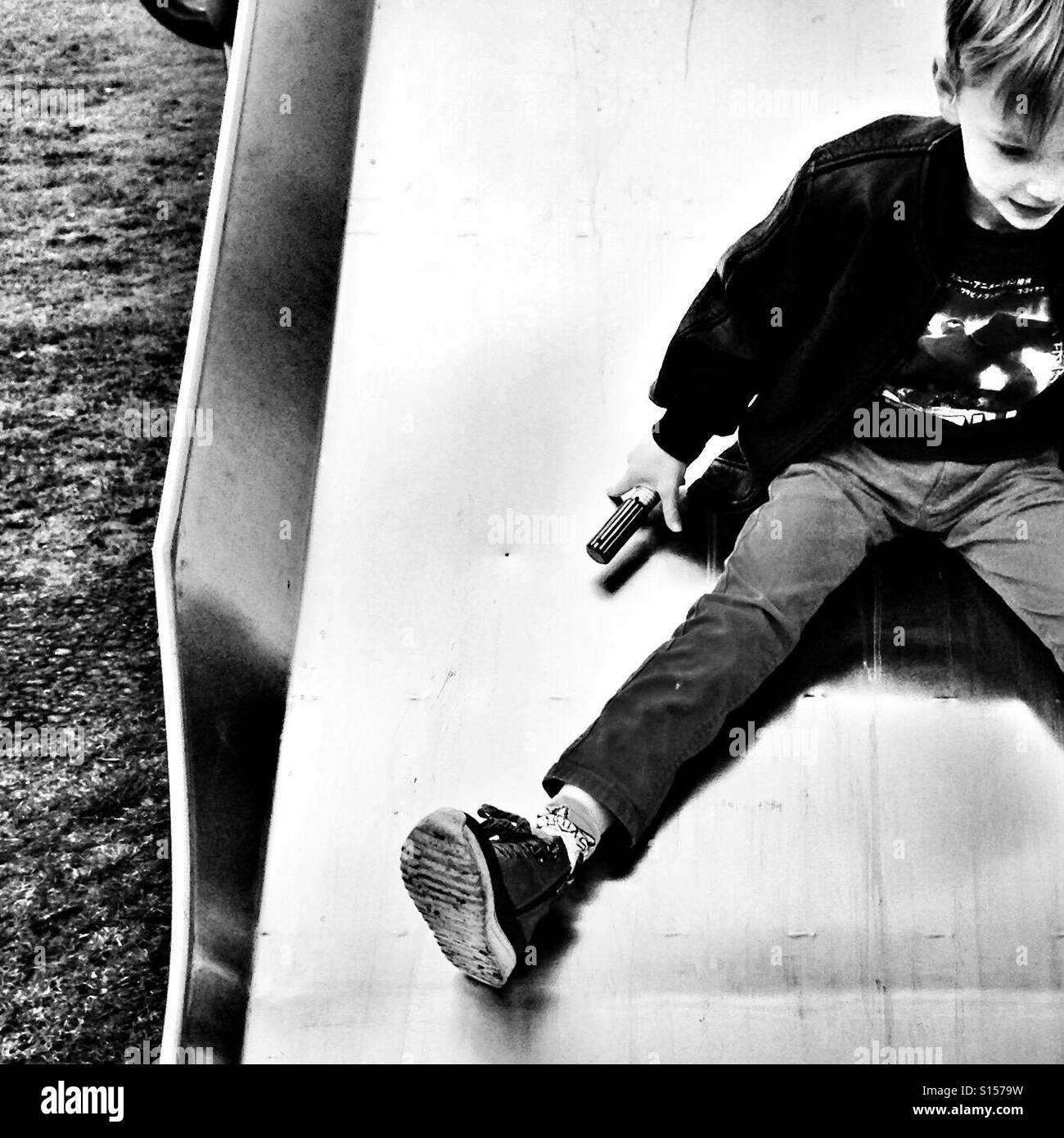 Boy on a slide Stock Photo - Alamy