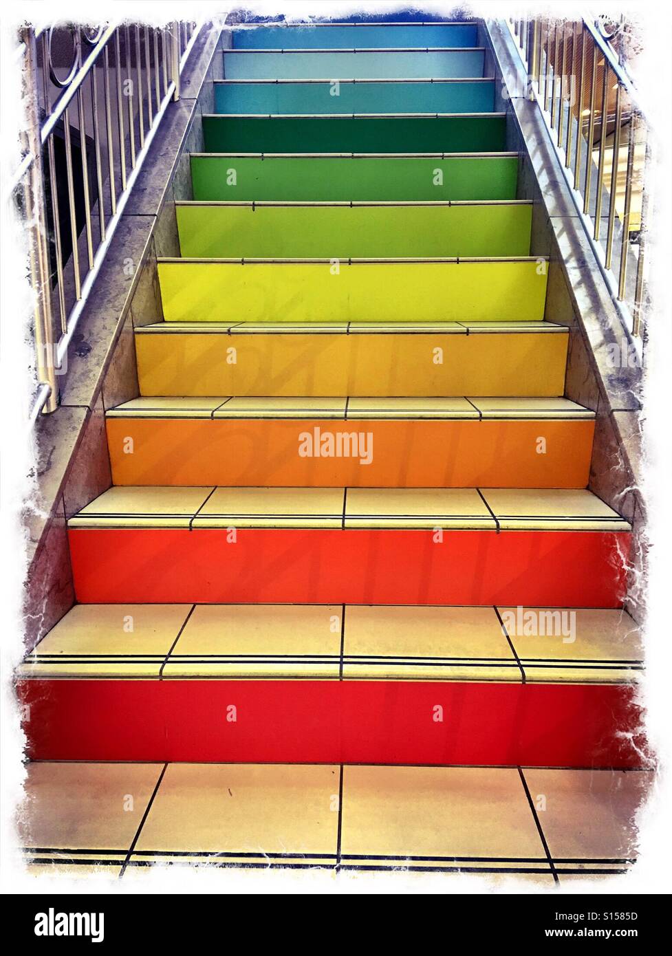 Looking up a rainbow staircase with risers of different colours/colors ...