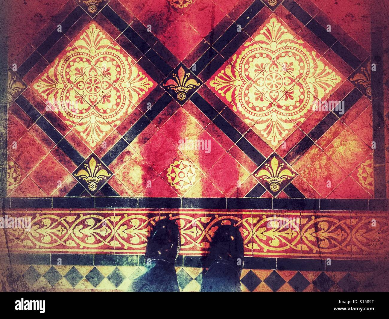 Feet and shadow on a tiled stone floor Stock Photo - Alamy