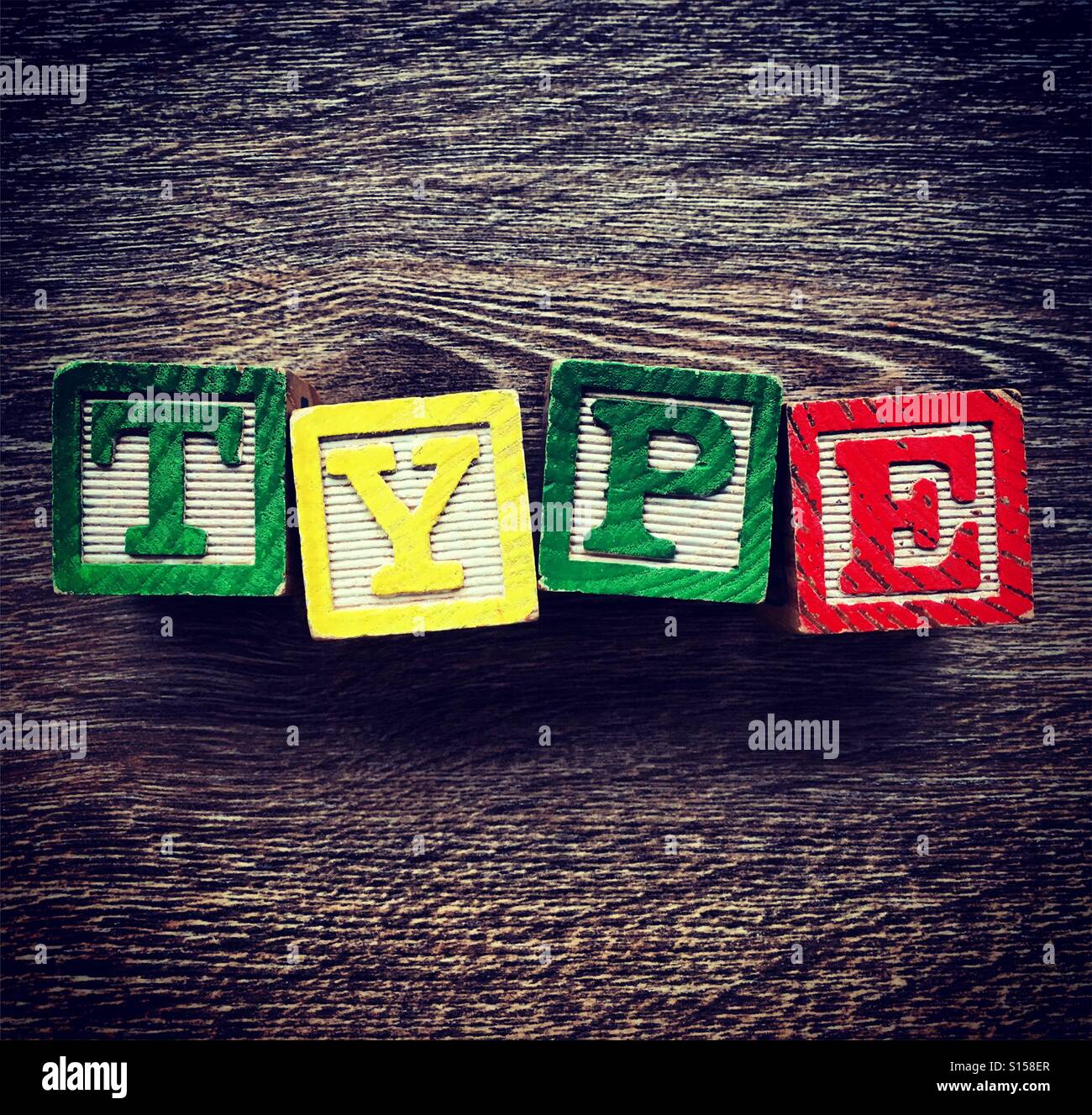 TYPE word written with wood block letter toys Stock Photo - Alamy