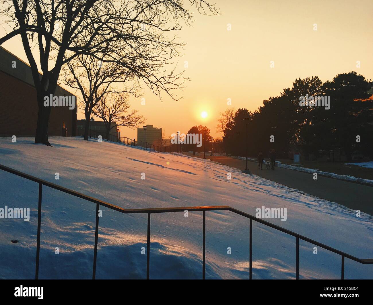The sun sets over a snowy college campus Stock Photo - Alamy