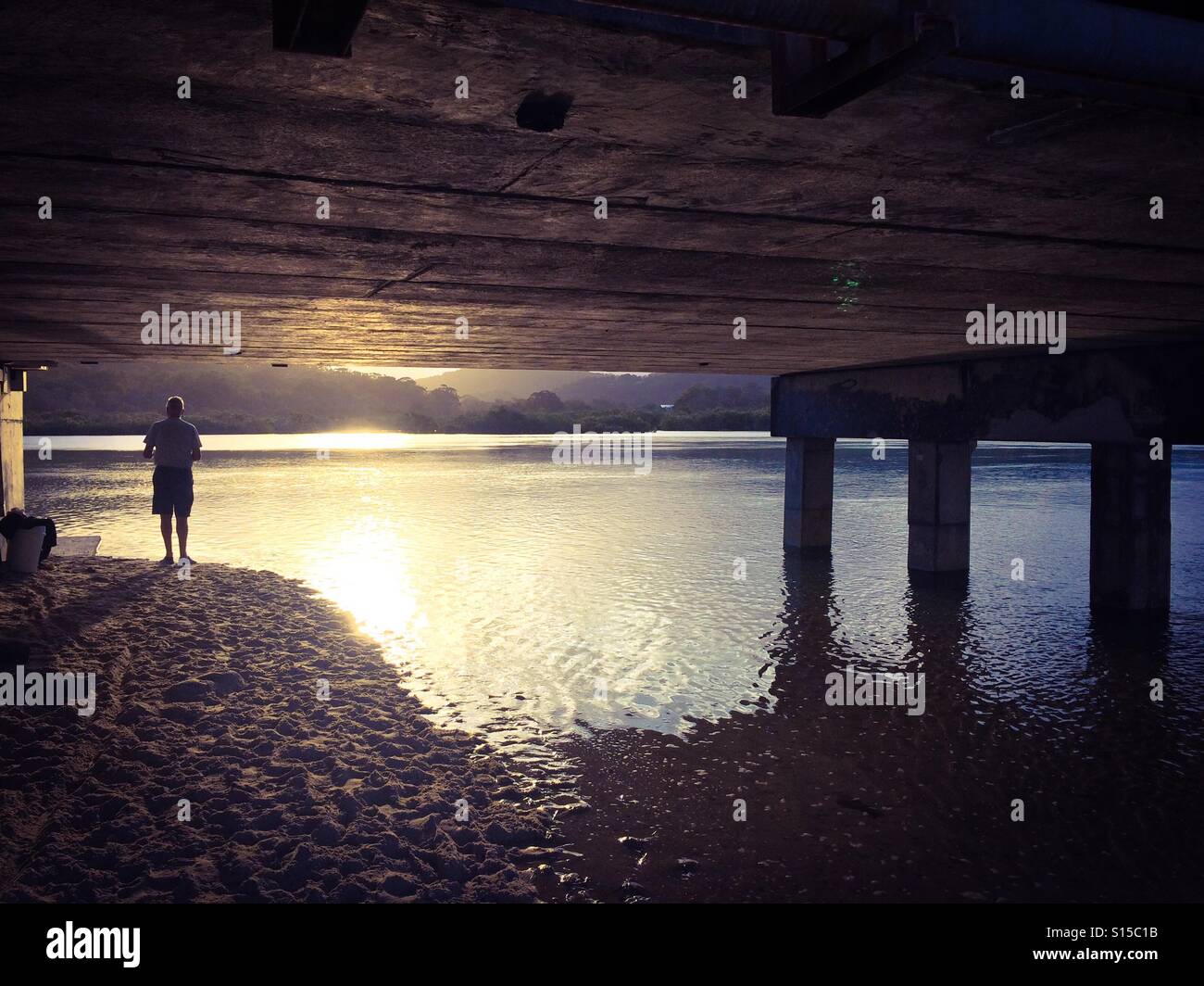 Fishing Under the Bridge Stock Photo - Alamy