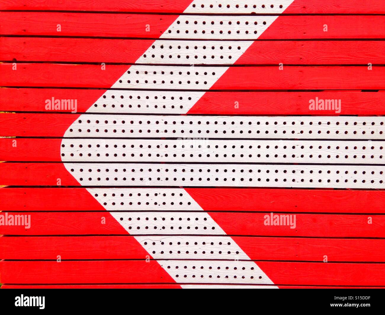 White arrow on a red board Stock Photo - Alamy