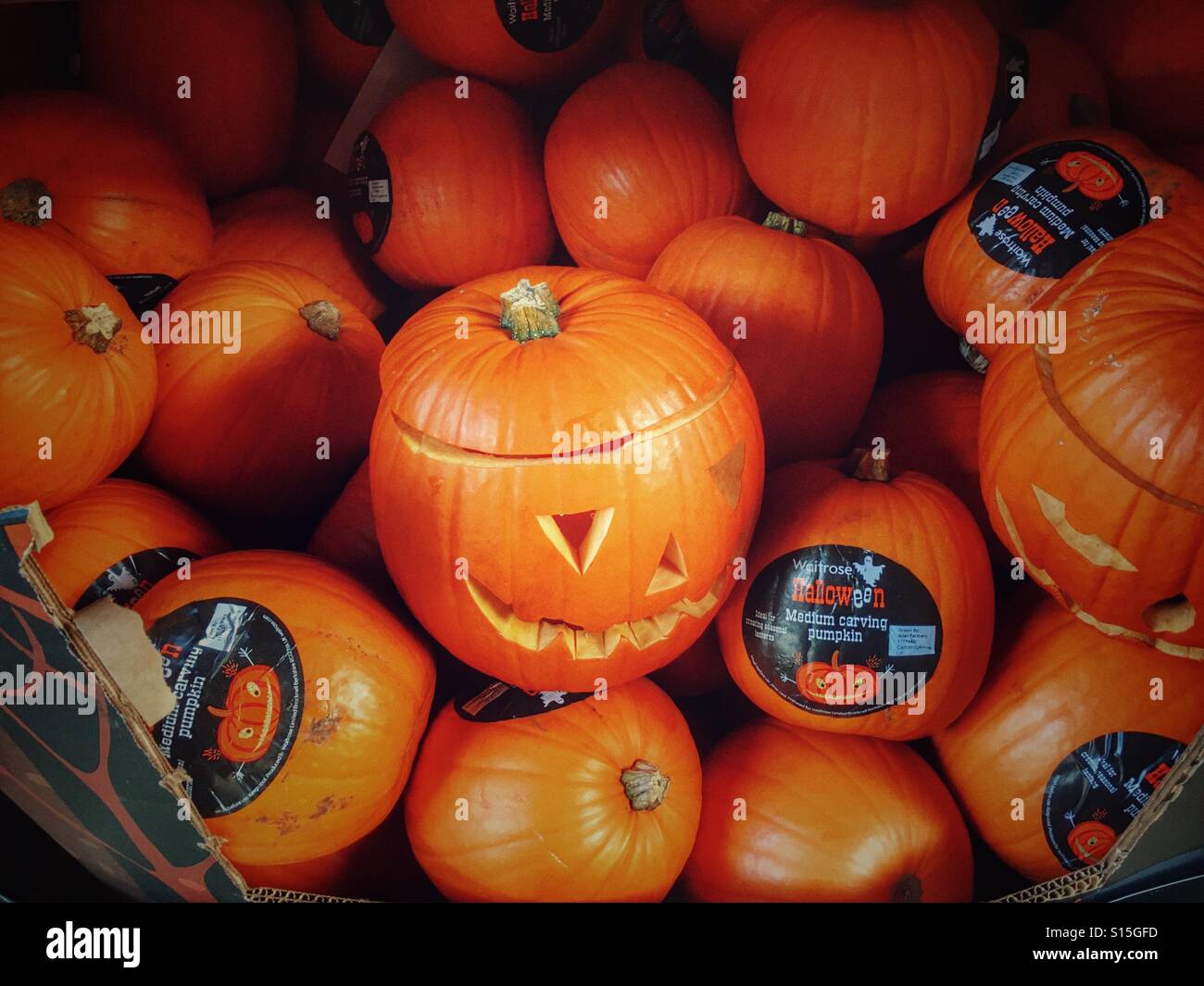 Pile of Halloween pumpkins for carving, outside a British supermarket ...