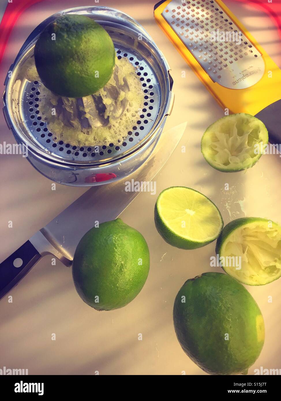 Limes and juicer in prep area in kitchen Stock Photo - Alamy