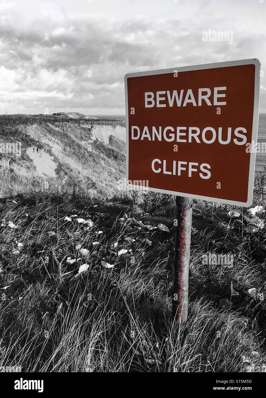 Warning sign - Text, Beware dangerous cliffs, on red background Stock ...