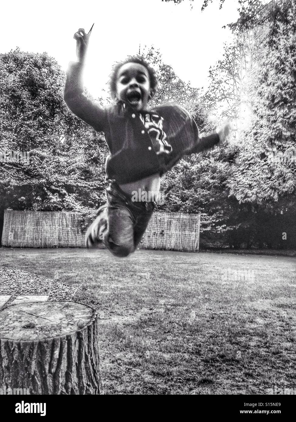 Black kid jumping hi-res stock photography and images - Alamy