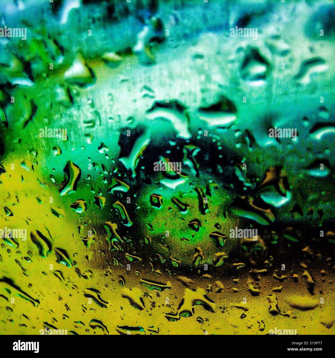 Raining day drops of water and car,s wheel through the car window Stock ...