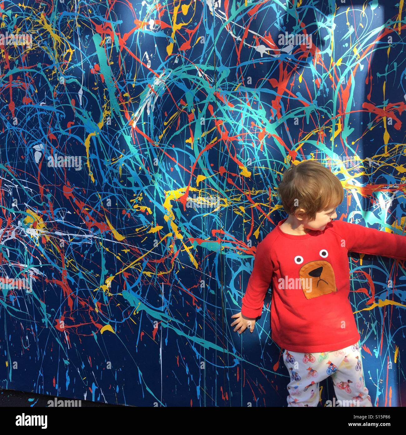 A young boy fascinated by an abstract mural artwork Stock Photo - Alamy