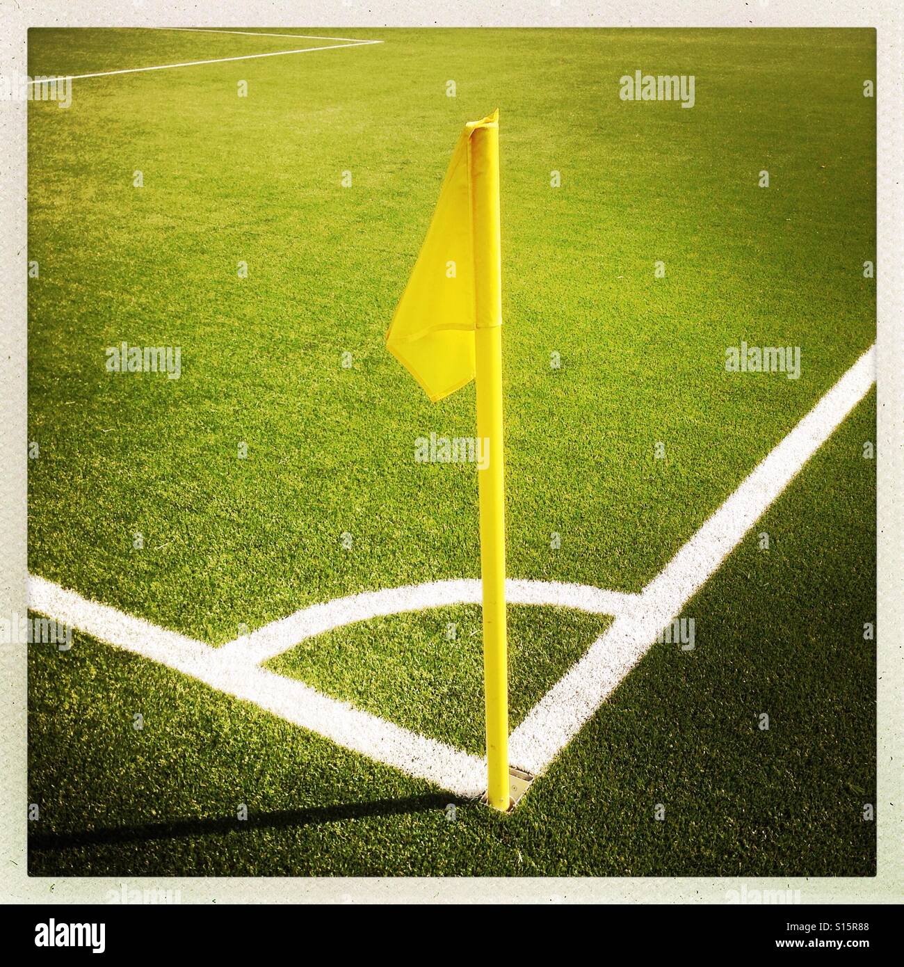 Yellow corner flag on artificial turf with white lines Stock Photo - Alamy