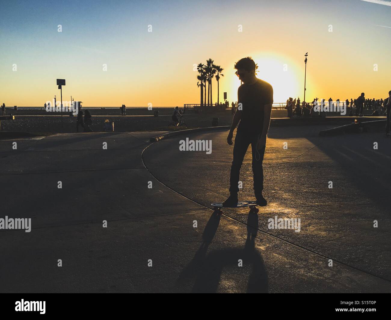 Man skating by the beach boardwalk Stock Photo - Alamy