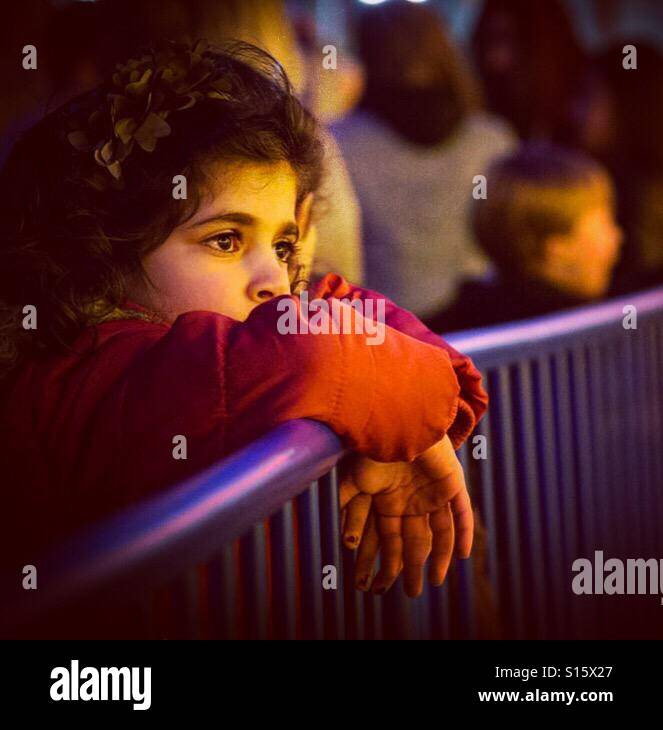 Girl looking over railings Stock Photo - Alamy