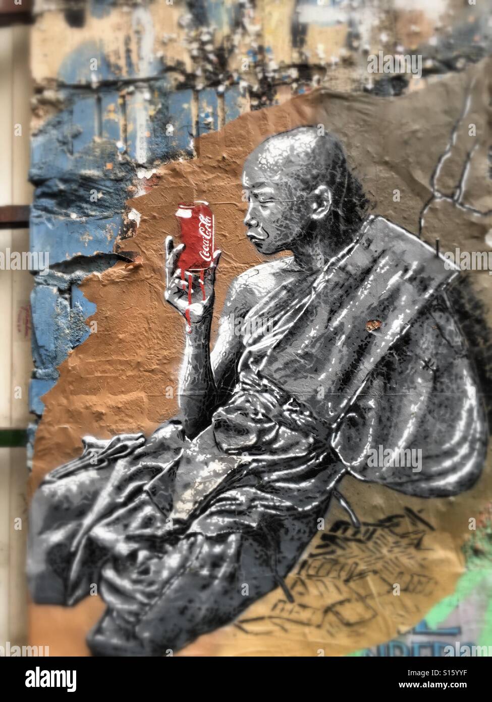 Graffiti of a buddhist monk holding a can of Coke Stock Photo - Alamy