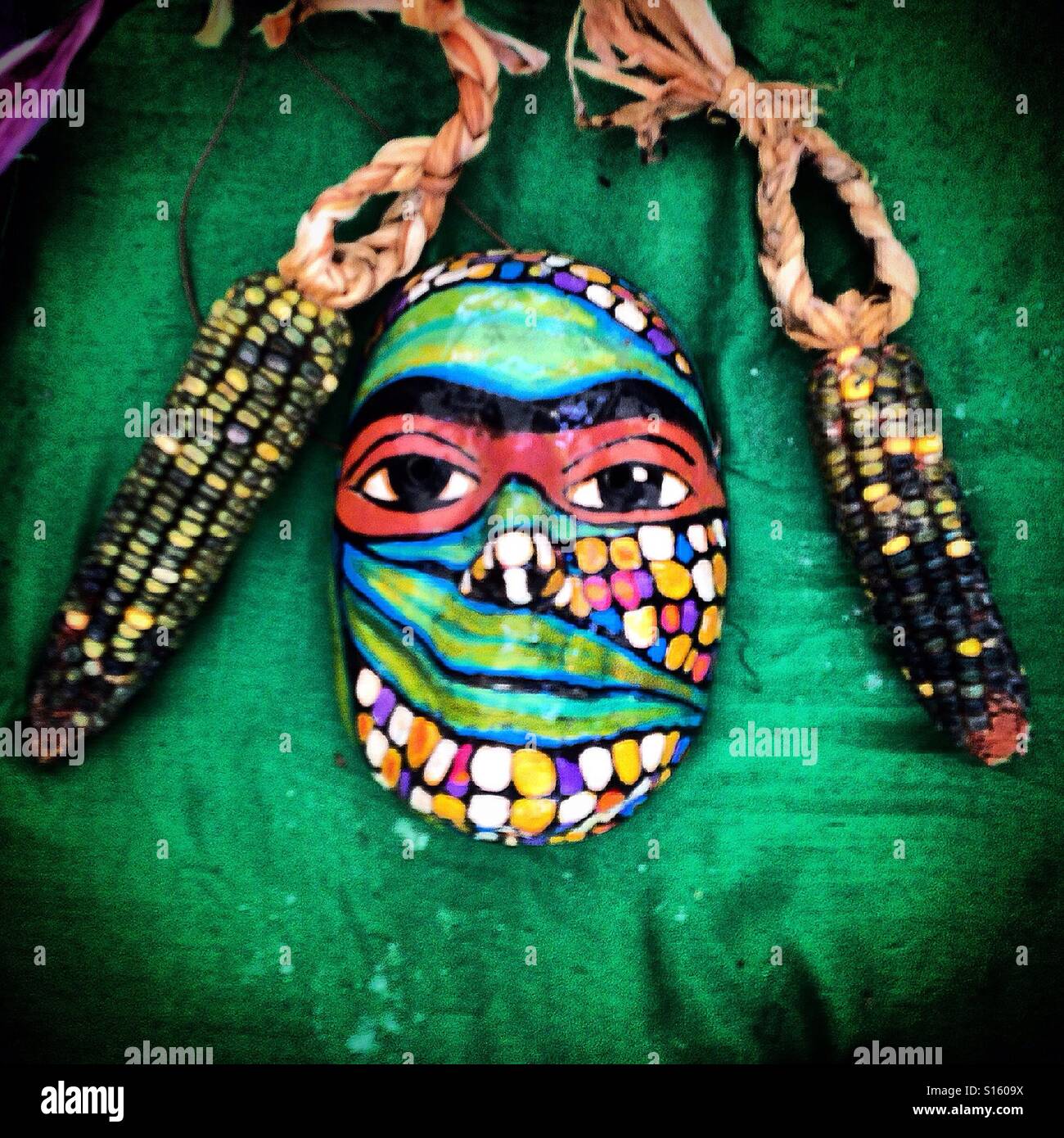 Colored native corn and a mask during a ceremony in Foro Tianguis ...