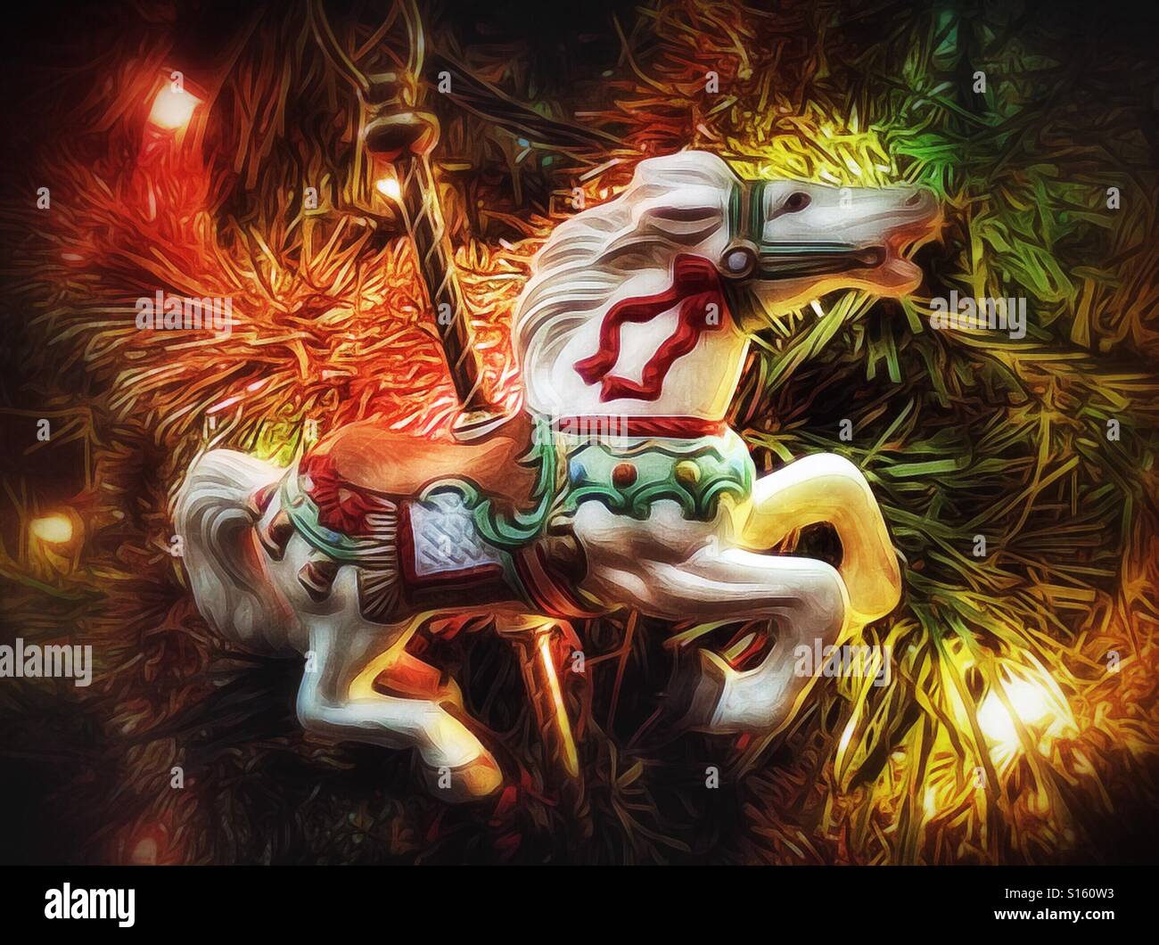 Carousel Christmas ornament hanging on a green Christmas tree with ...