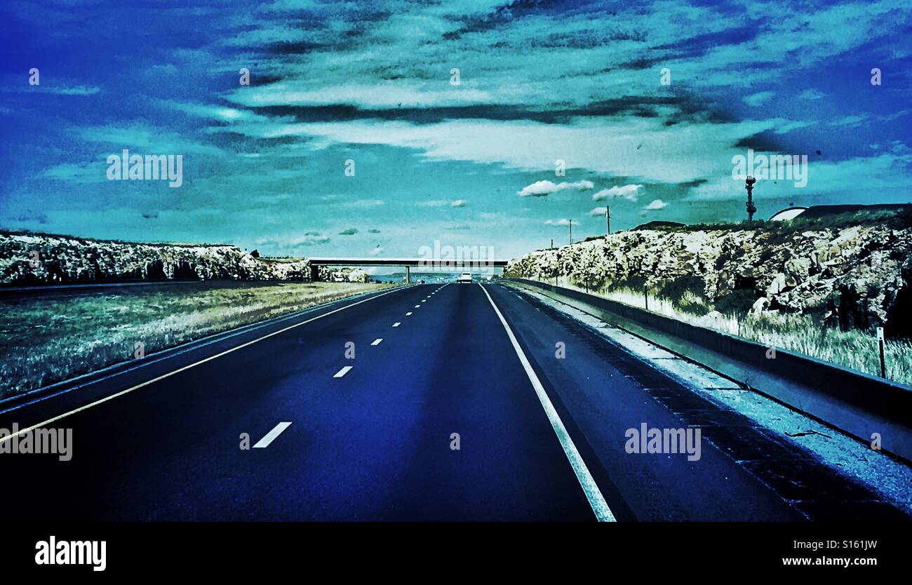 Empty Blue highway stretching mikes down the road Stock Photo - Alamy