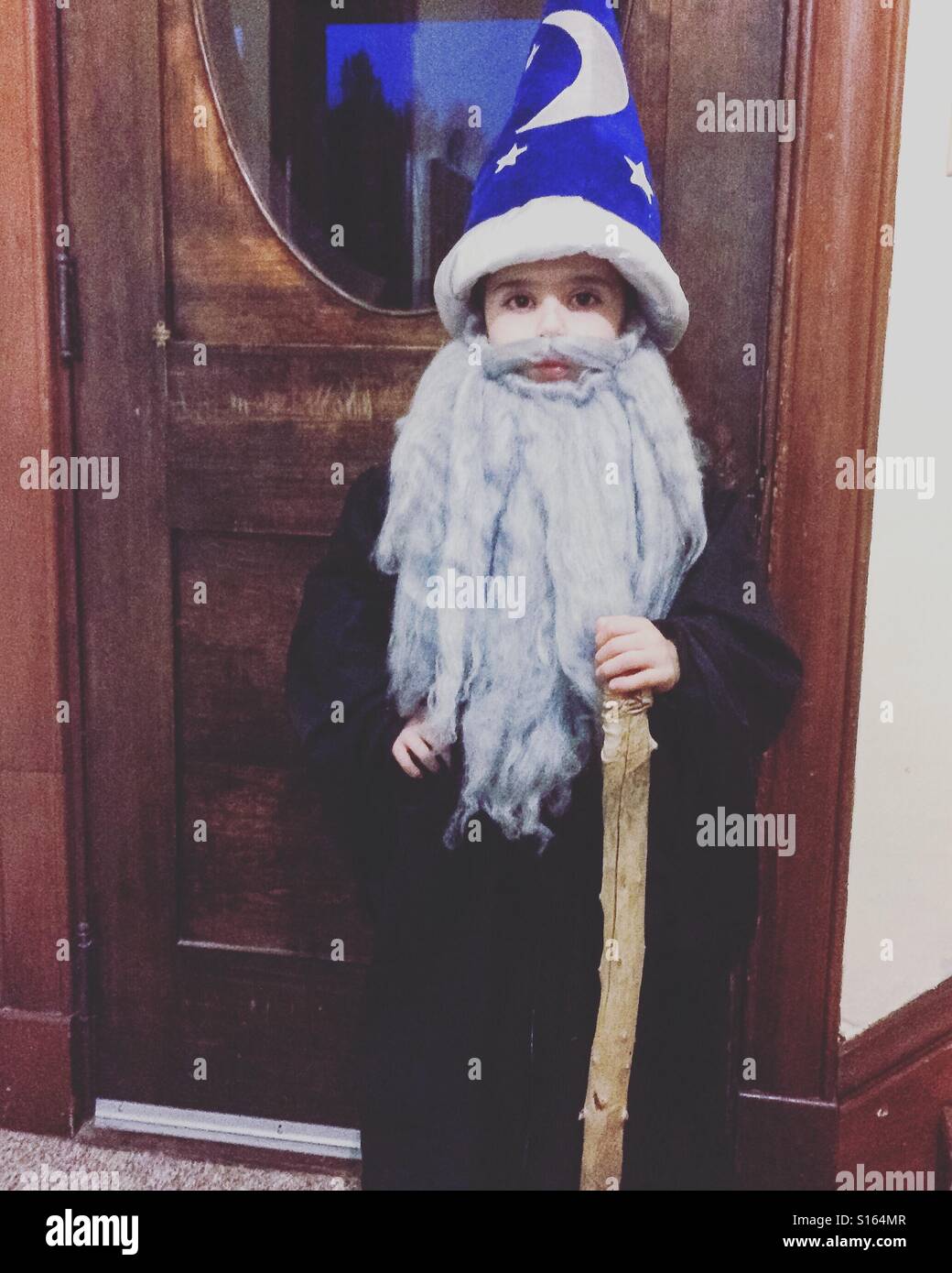 A six year old boy dressed as a Wise wizard for Halloween. He's wearing ...
