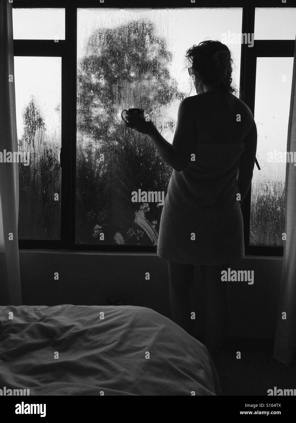 Women drinking coffee in front on window Stock Photo - Alamy