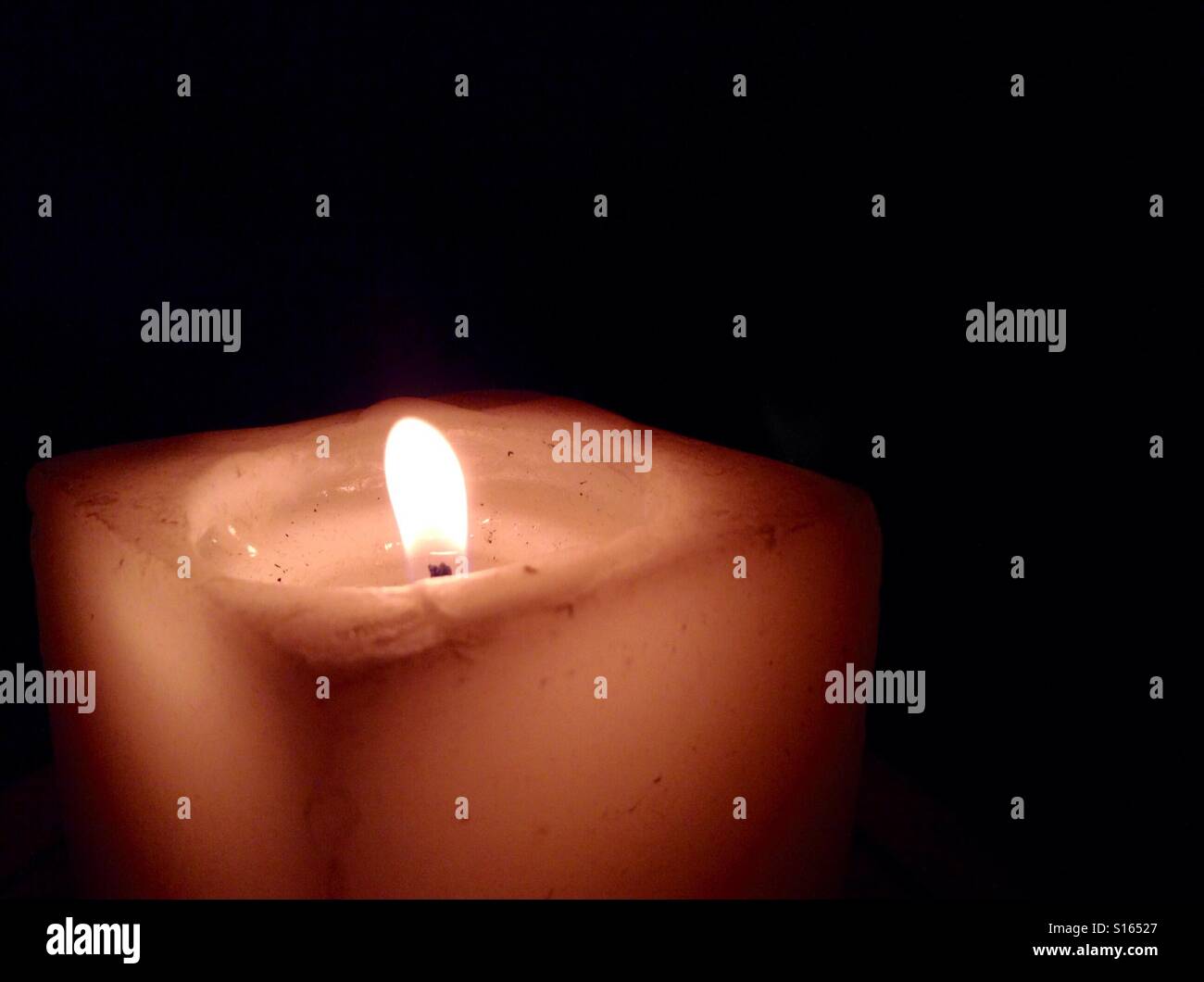 Lit candle in dark hi-res stock photography and images - Alamy