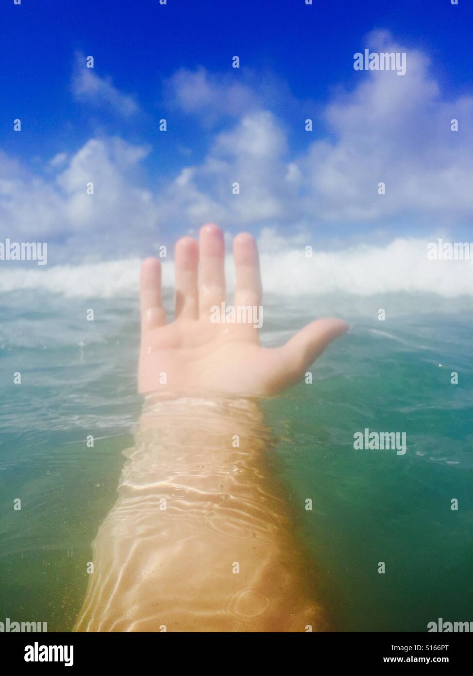 A hand coming out of the water. Maui Hawaii USA Stock Photo - Alamy