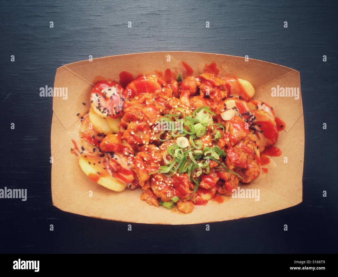 A paper dish with Korean BBQ takeout Stock Photo - Alamy