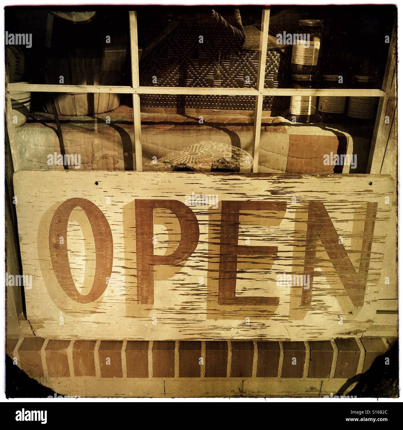 Old wooden sign in storefront window Stock Photo - Alamy