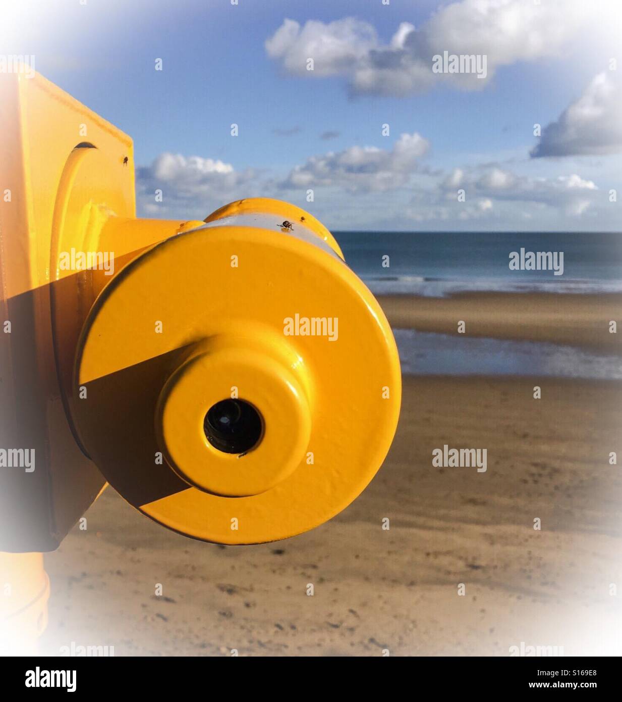 Seaside telescope closeup with sea and beach background Stock Photo - Alamy