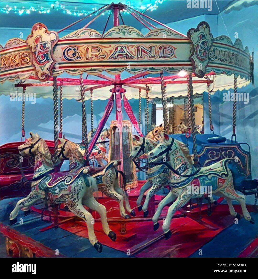 Galloping horses carousel Stock Photo - Alamy