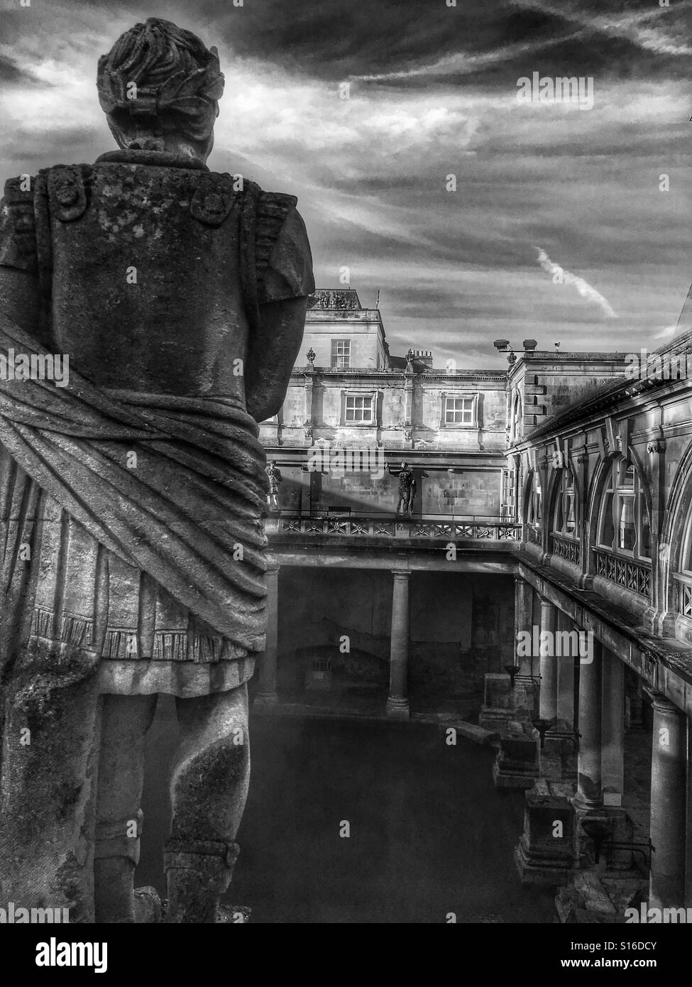 Statue on an upper terrace looking down to The Great Bath below. The ...