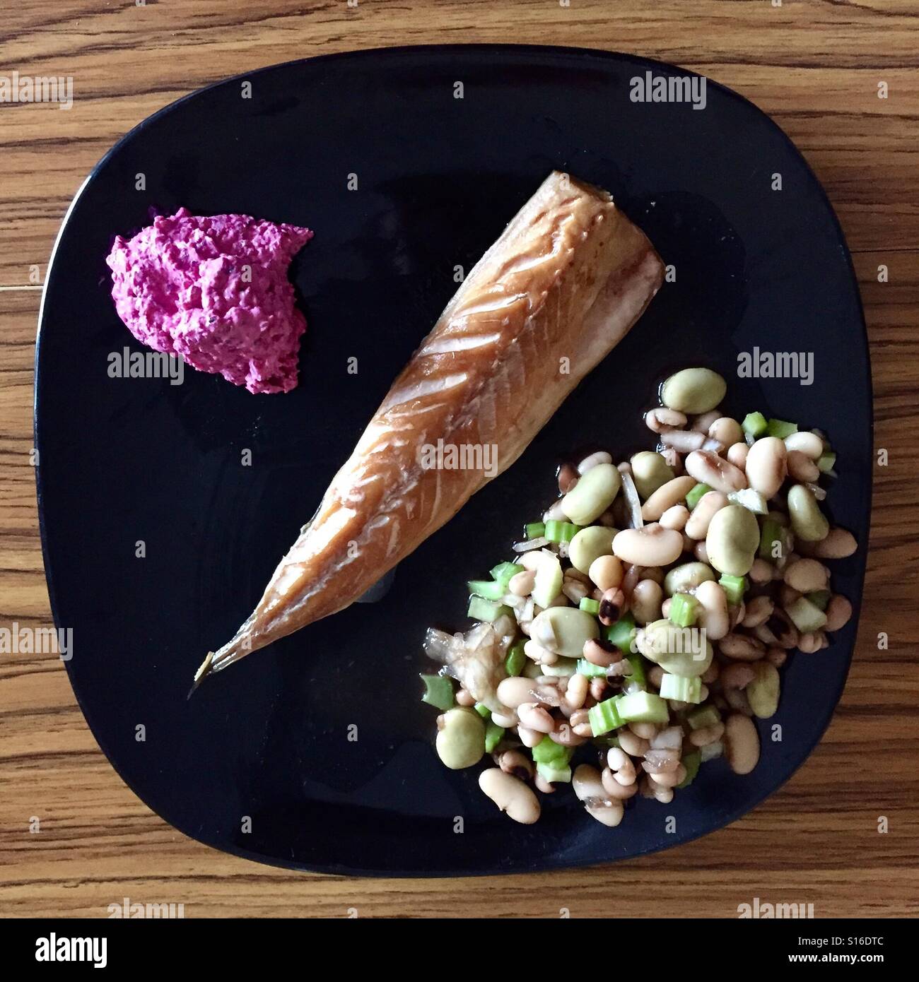 Lunch with fish, beetroot cream and bean salad Stock Photo - Alamy
