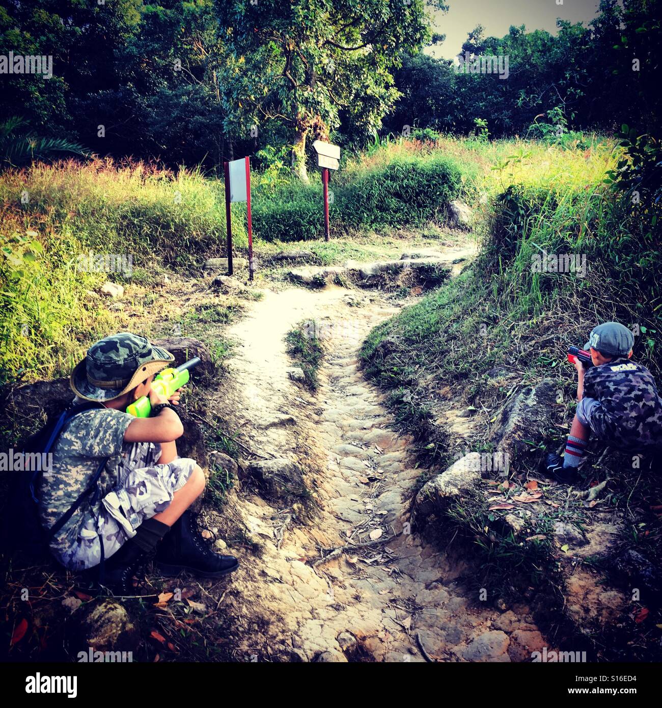 Ambushing while playing soldiers warrior in a tropipcal jungle foot ...