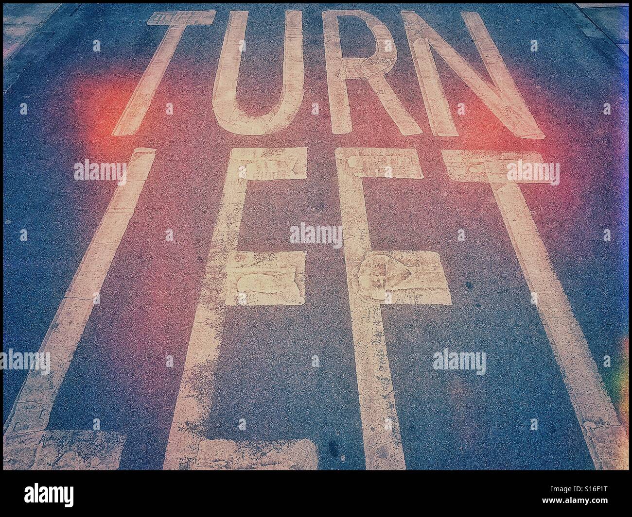 "TURN LEFT" Writing on a Tarmac Road, instructing road users they are ...