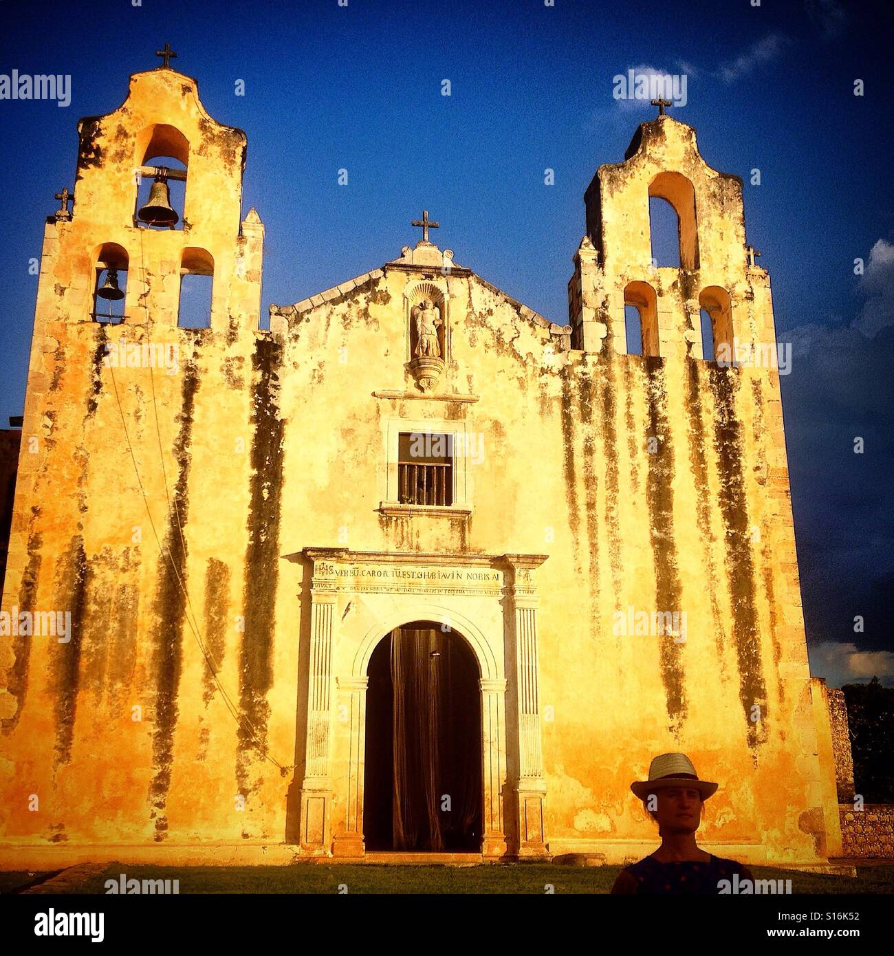 A tourist walks outside the church of Mani, Yucatan, Mexico Stock Photo ...