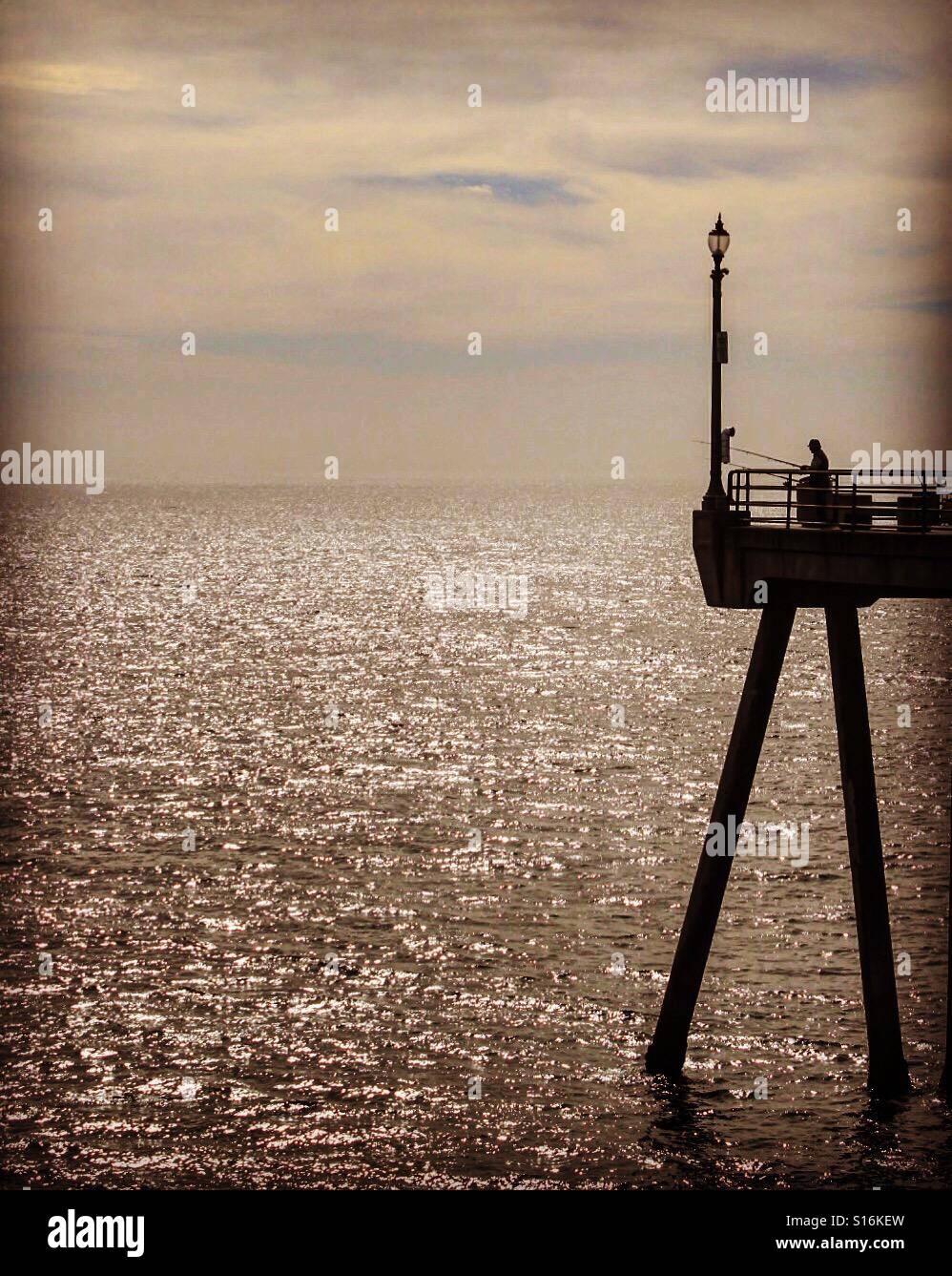 Fishing off the pier Stock Photo - Alamy