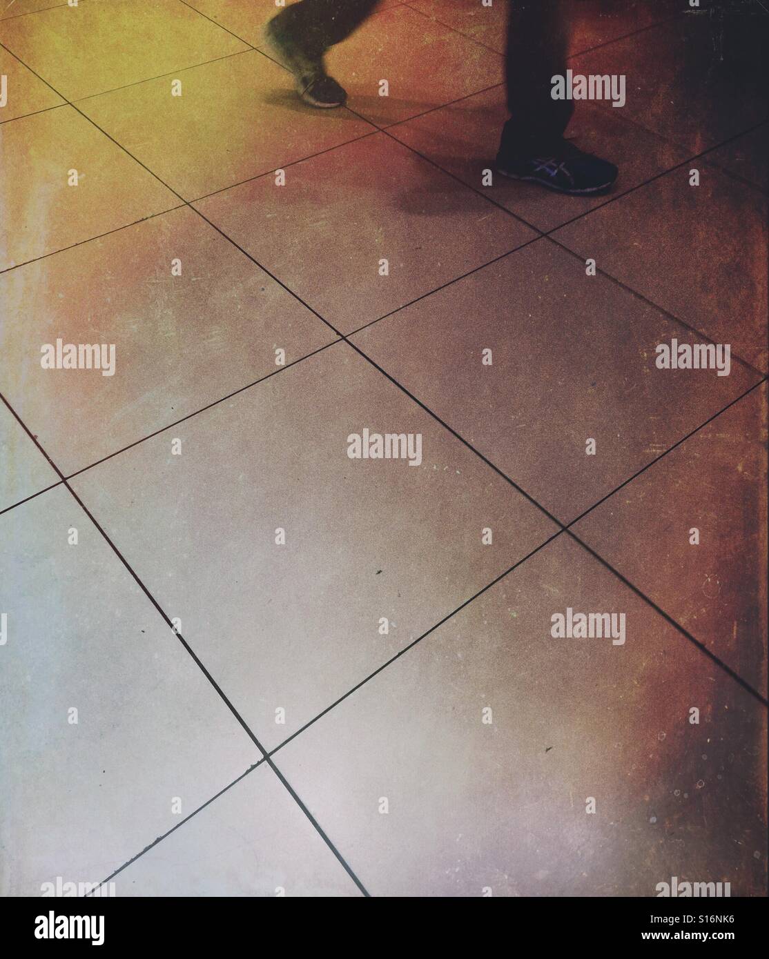Walking over a tiled floor Stock Photo - Alamy