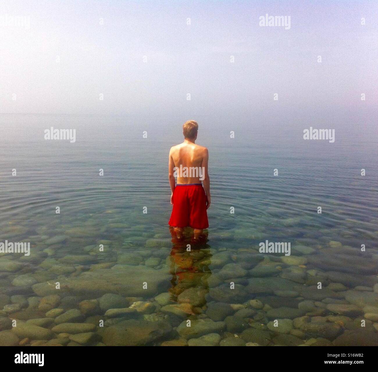 Man standing in lake Stock Photo - Alamy