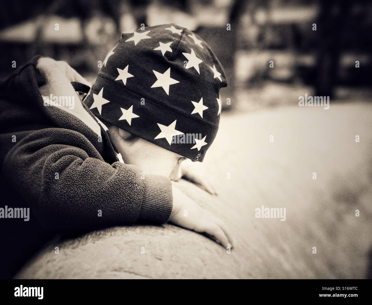 Young child looking over with curiosity Stock Photo - Alamy