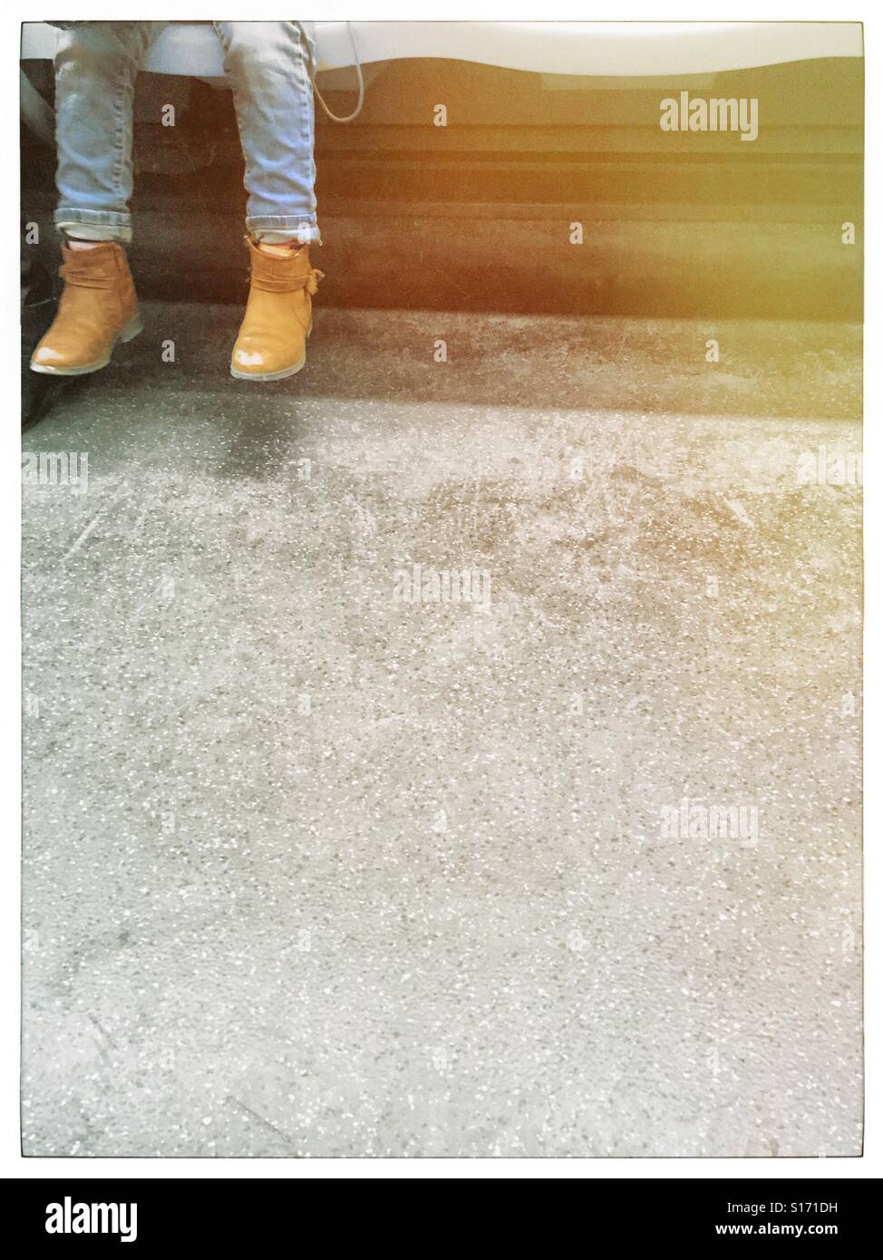 Kid sitting on a bench inside a subway car Stock Photo - Alamy