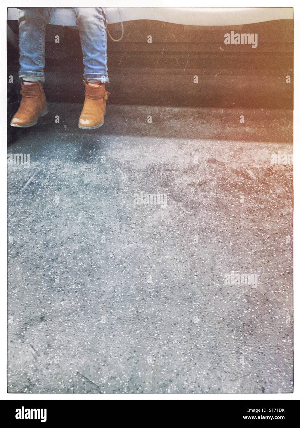 Kid sitting on a bench inside a subway car Stock Photo - Alamy