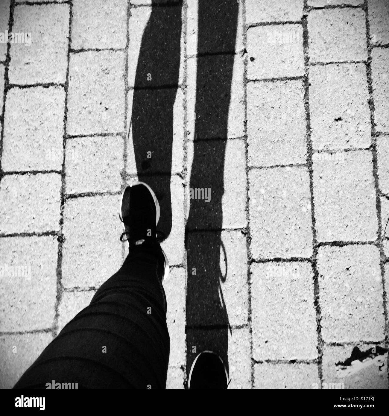 Walking on my shadow Stock Photo - Alamy