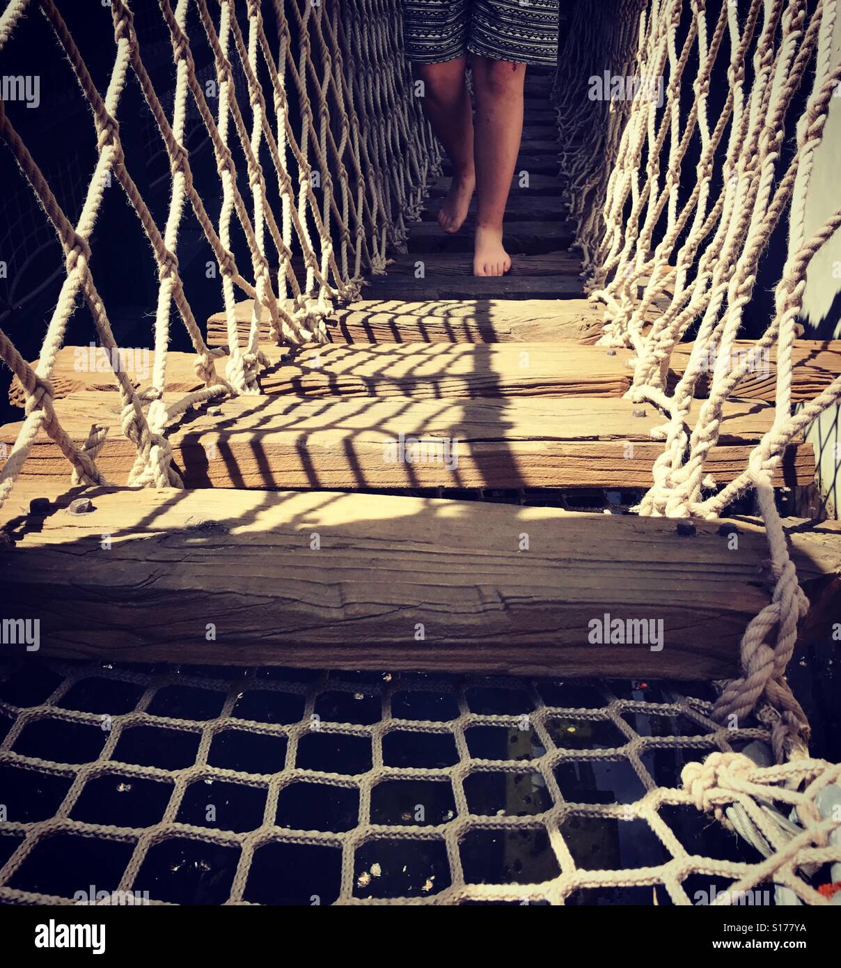 Child crossing rope bridge hi-res stock photography and images - Alamy