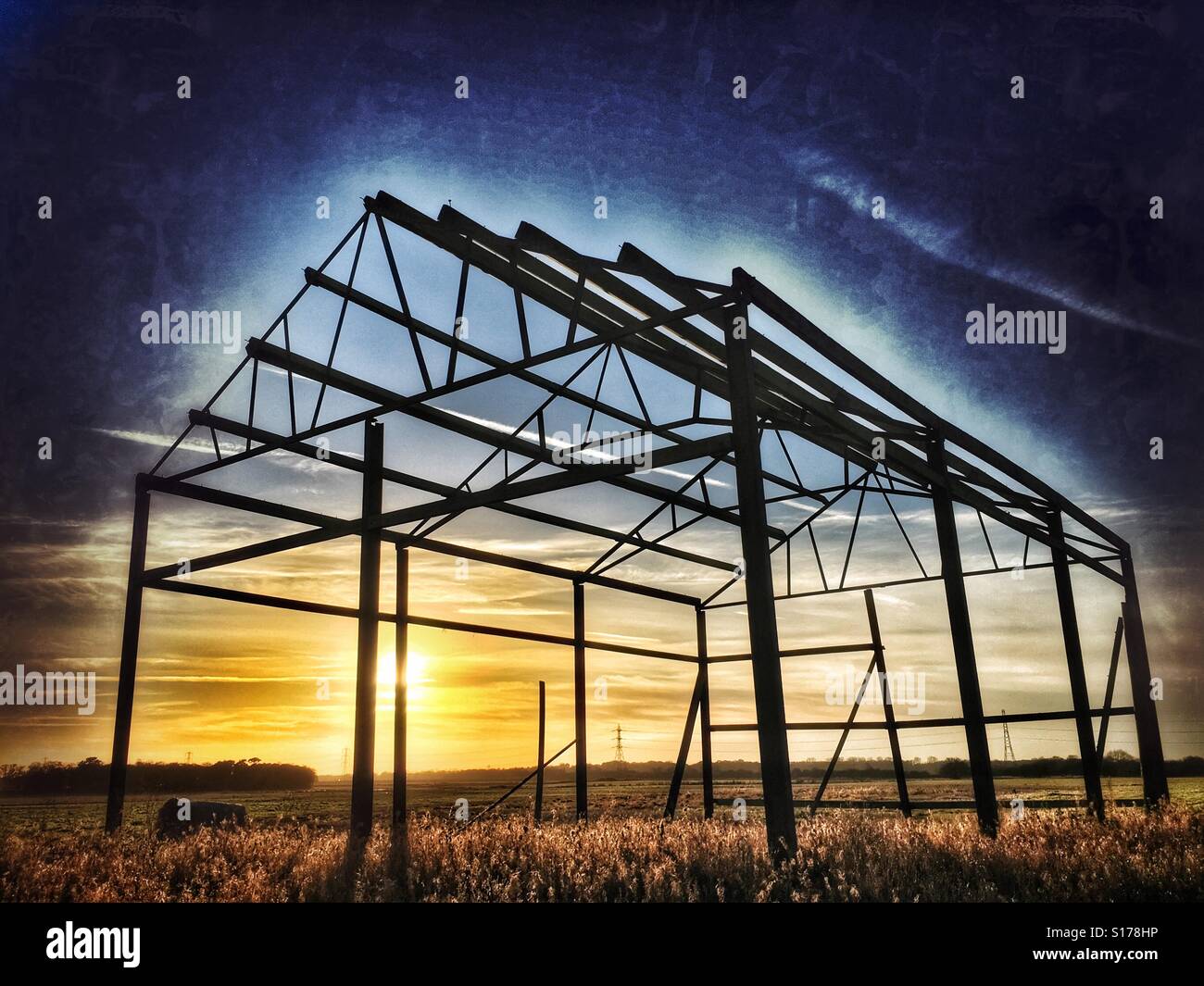 Skeleton of barn in silhouette against late afternoon sun Stock Photo ...