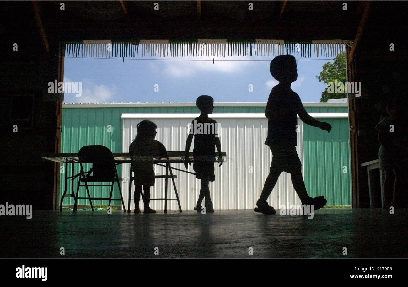 Kids walk through a barn at a county fair Stock Photo - Alamy