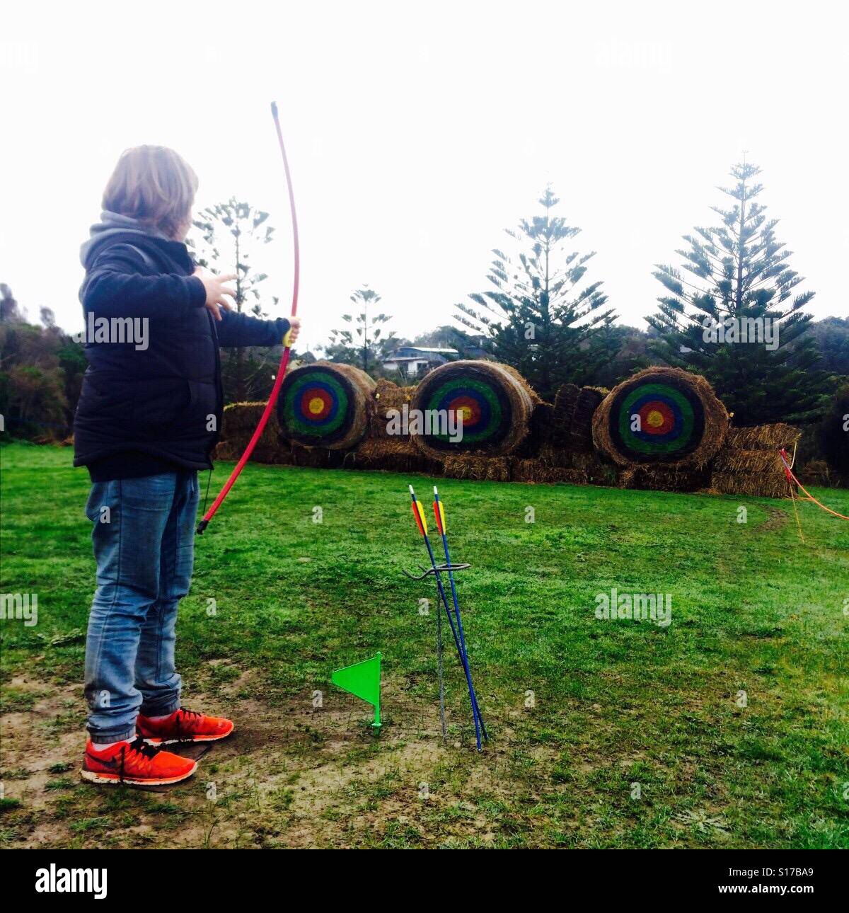Boy playing archery in winter Stock Photo - Alamy